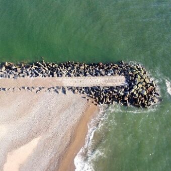 Aerial view of a groyne on a beach, breakwater, coastal protecti ...